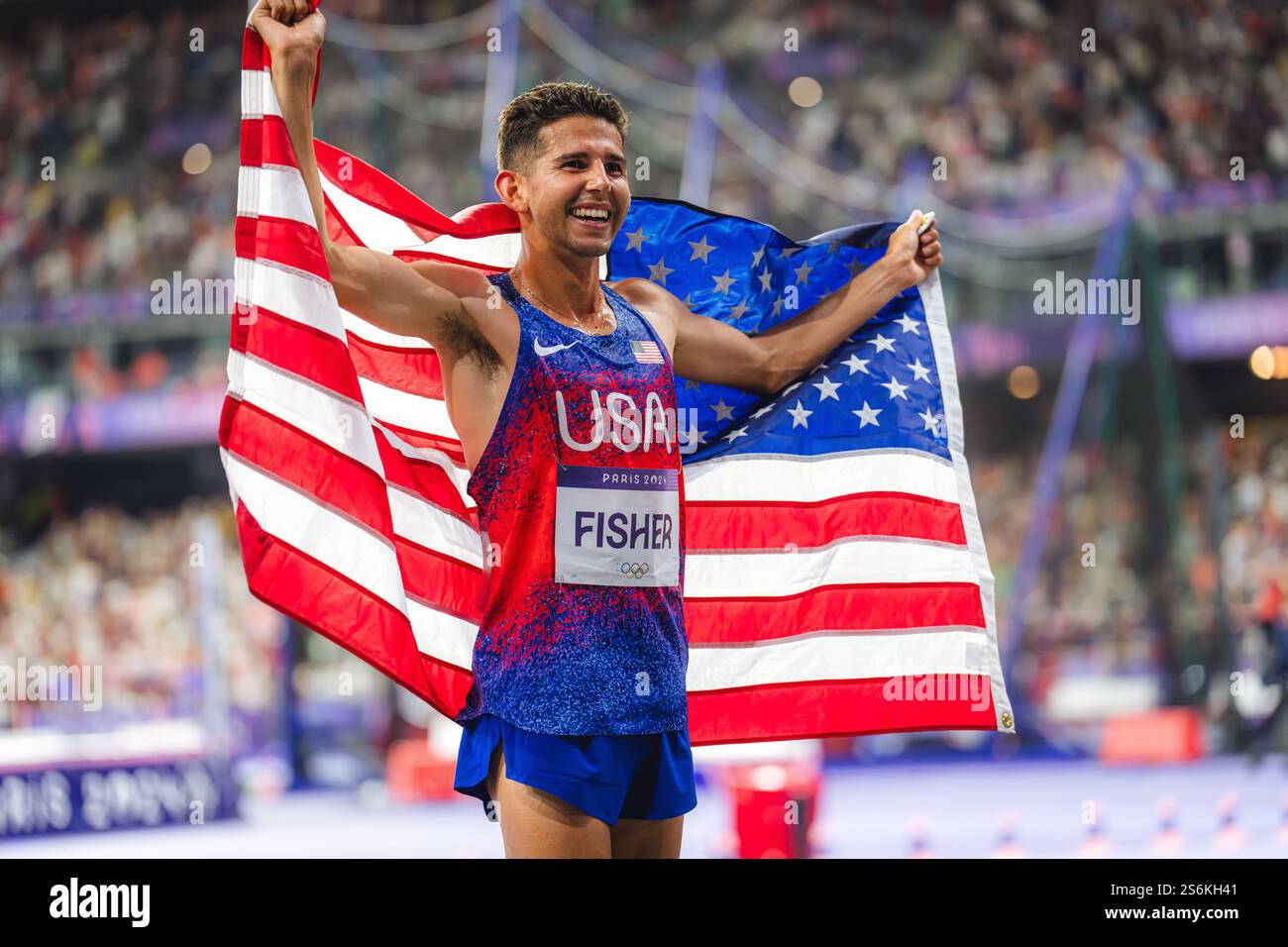 Grant Fisher celebrating her medal with her country's flag at the Paris ...