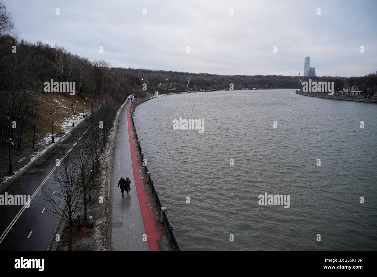 People walk along Vorobyovskaya embankment of the Moskva river in ...