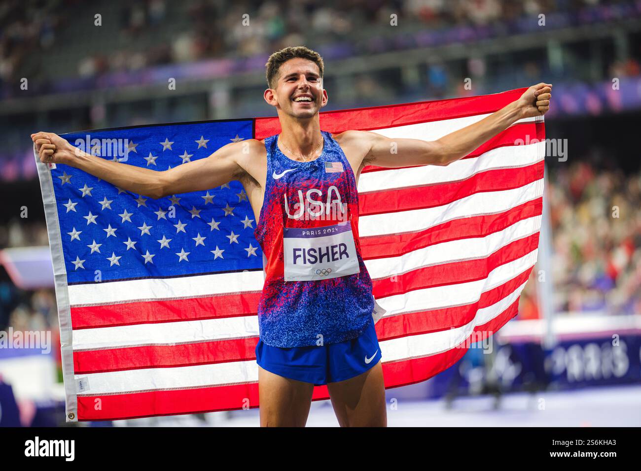 Grant Fisher celebrating her medal with her country's flag at the Paris ...