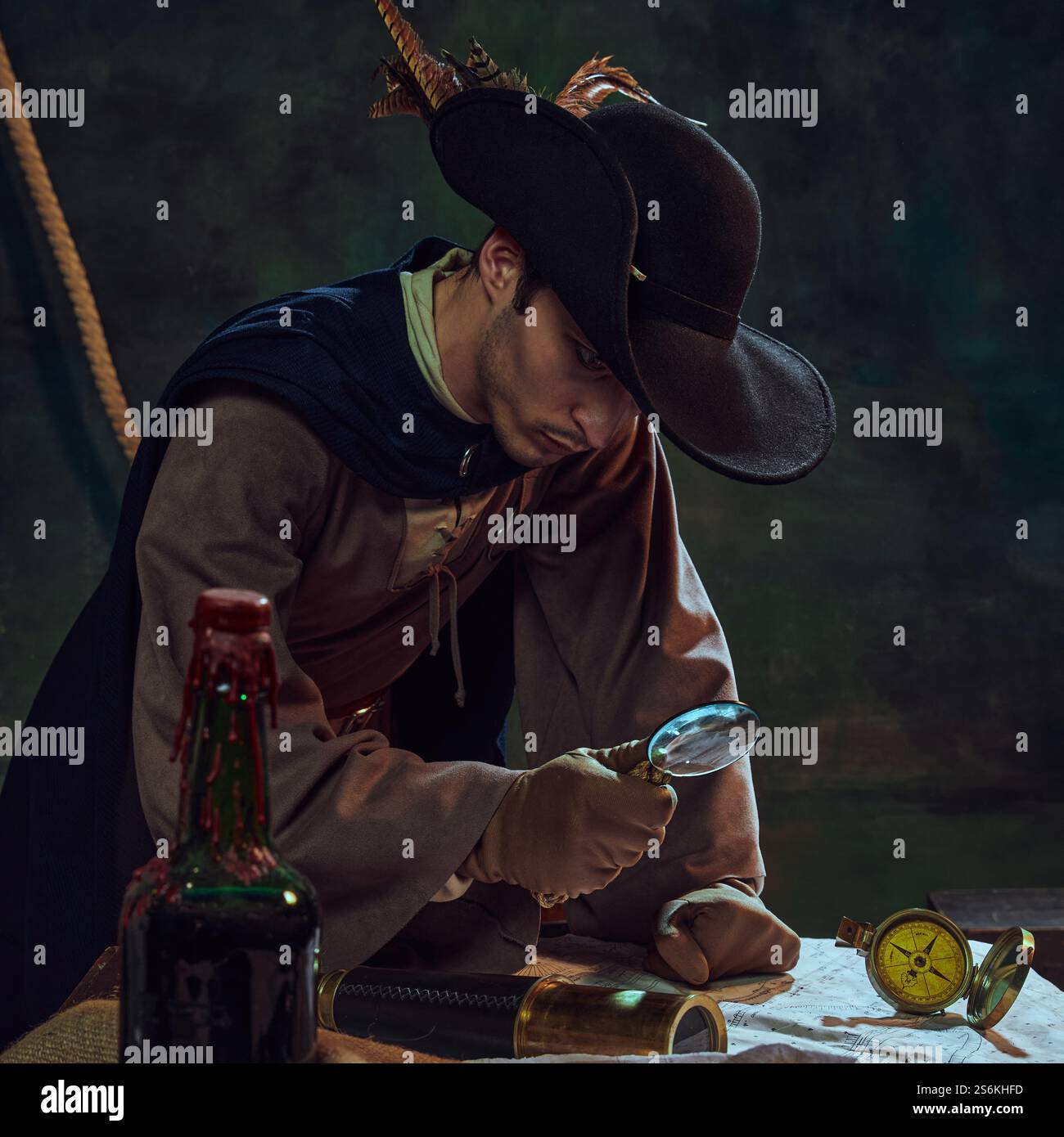 Concentrated man, pirate captain in feathered hat carefully examines ...