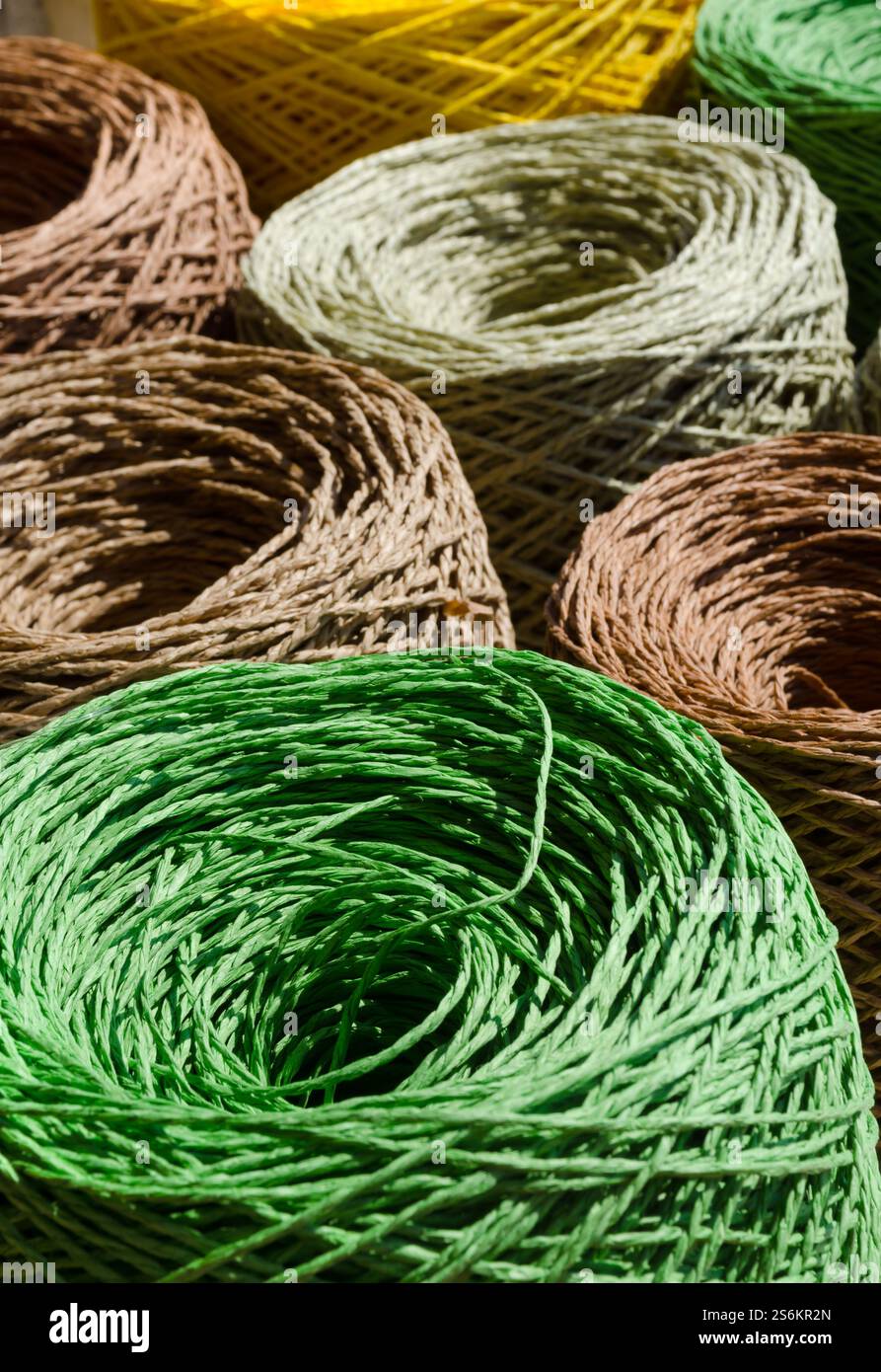 Rolls of colored raffia close-up. Skeins of multi-colored raffia. Eco ...