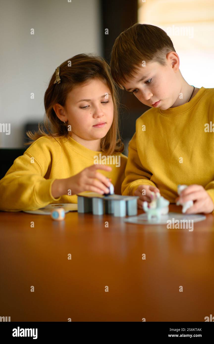 Boy and girl enjoying a game of chess hi-res stock photography and ...