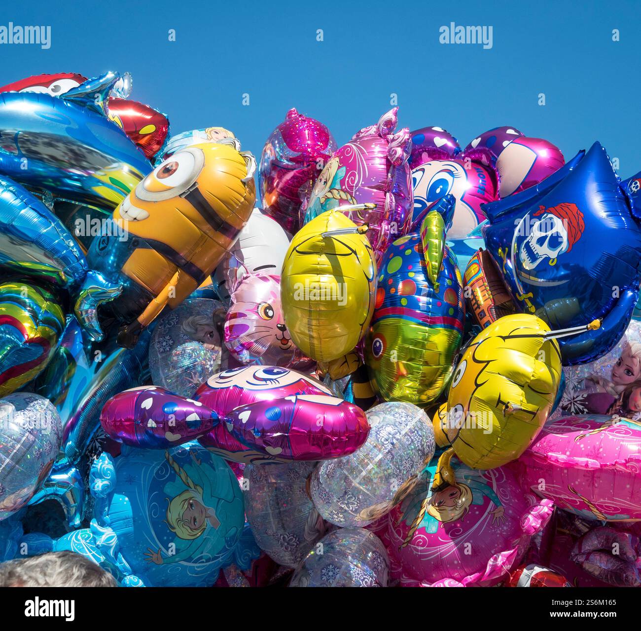 Cluster of inflatable balloons of various shapes, designs and colors ...