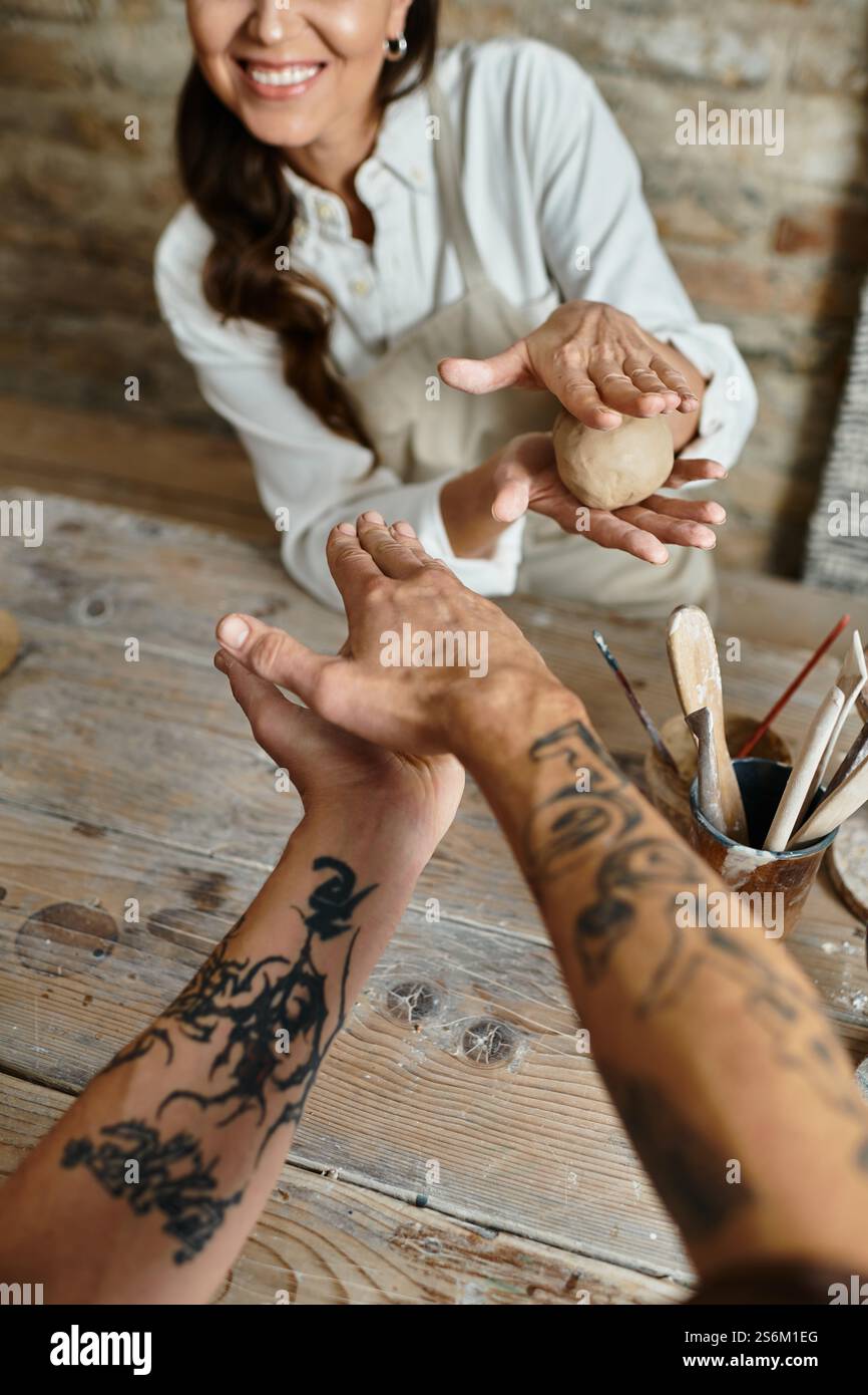 Couple passionately shaping clay in a pottery class, enhancing their ...
