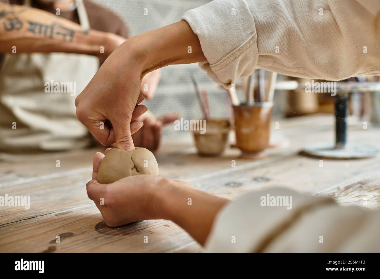 Couple joyfully shaping clay together in a pottery class, strengthening ...