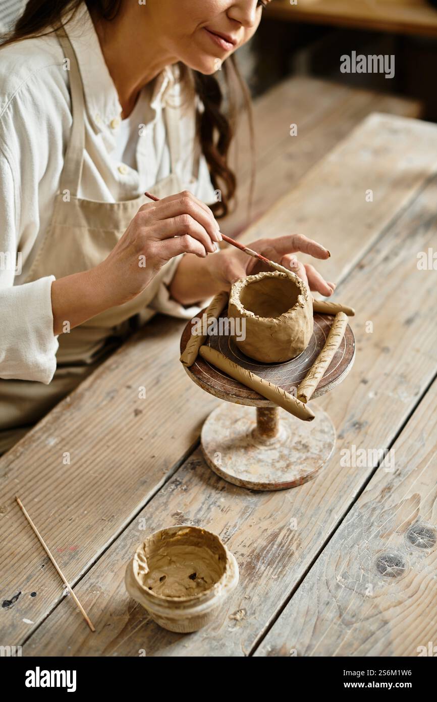 A beautiful mature couple enjoys shaping clay during a pottery class ...