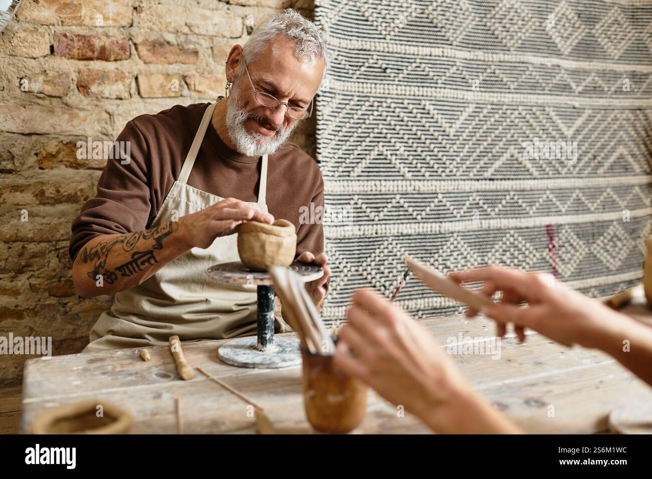 Mature couple bonds over clay in pottery class, enhancing creativity ...