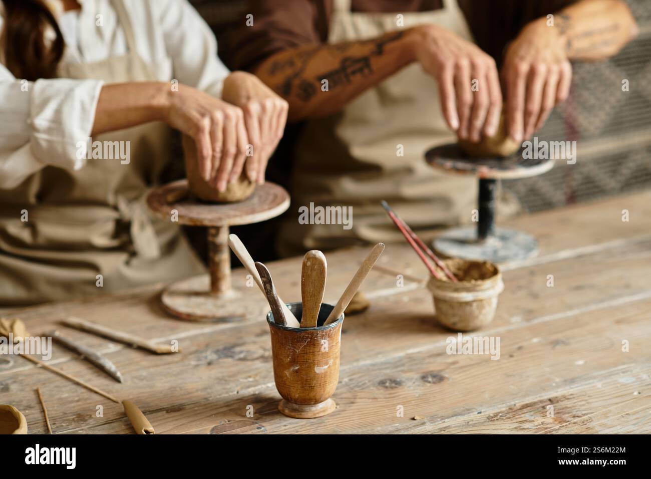 In a pottery class, a mature couple enjoys shaping clay, bonding over ...