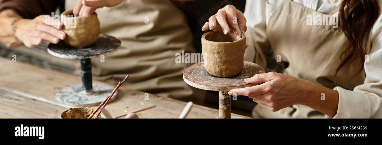 A cropped couple shares quality time as they mold clay during their ...