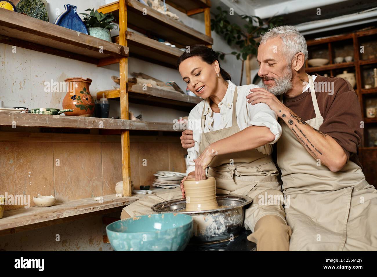 Couple shares a delightful pottery class, shaping clay together while ...