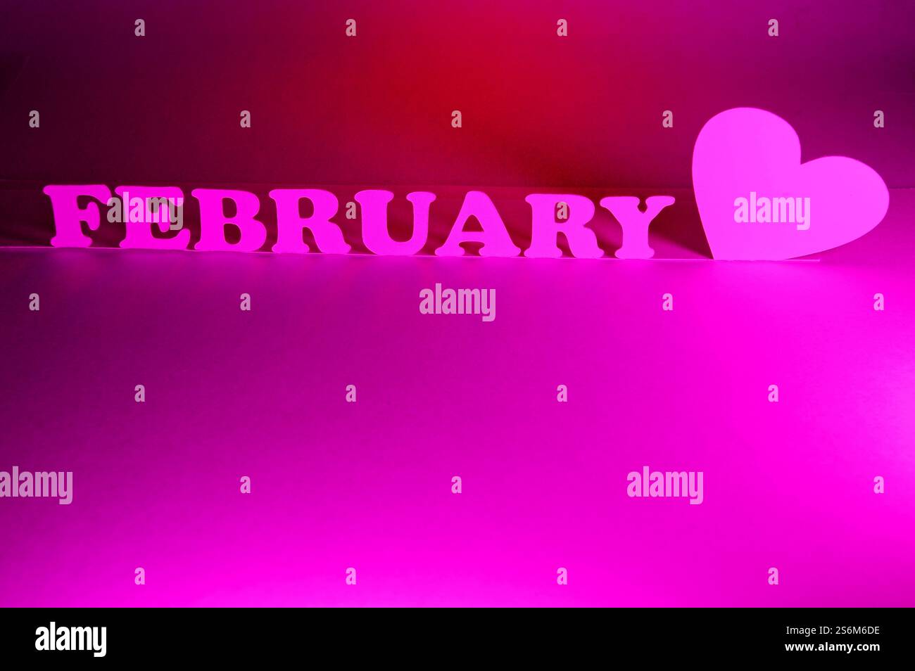 February with a heart and pink light Stock Photo - Alamy