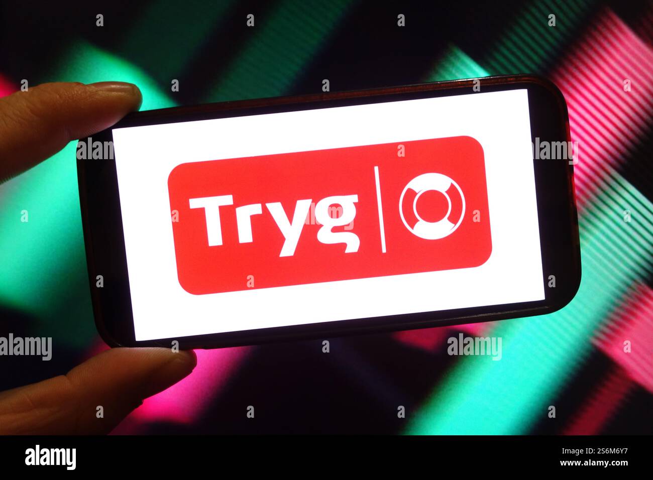 In this photo illustration, the Tryg company logo is seen displayed on ...