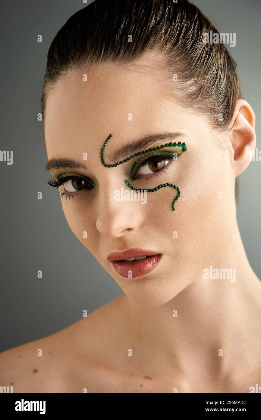 A stunning young model showcases intricate snake makeup artistry in a ...