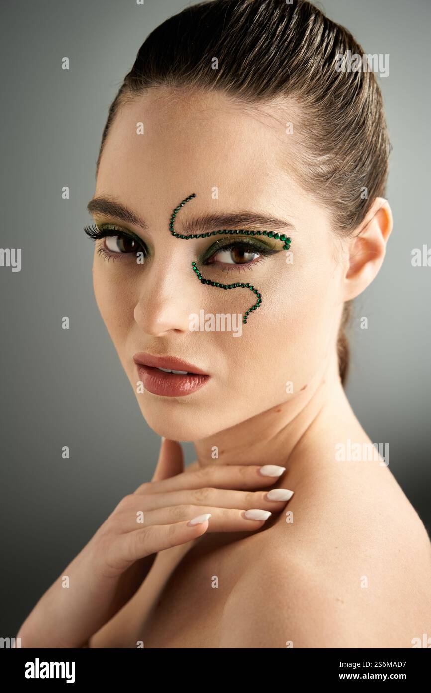 A talented model showcases captivating snake makeup in a well-lit ...