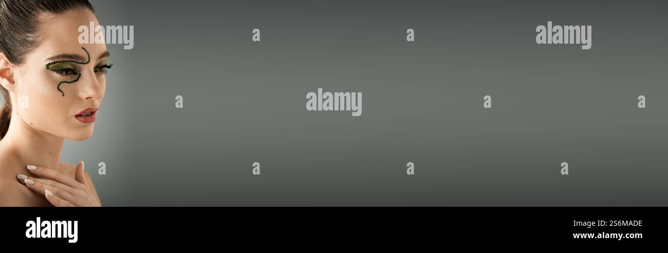 A beautiful young woman showcases stunning snake makeup while posing ...