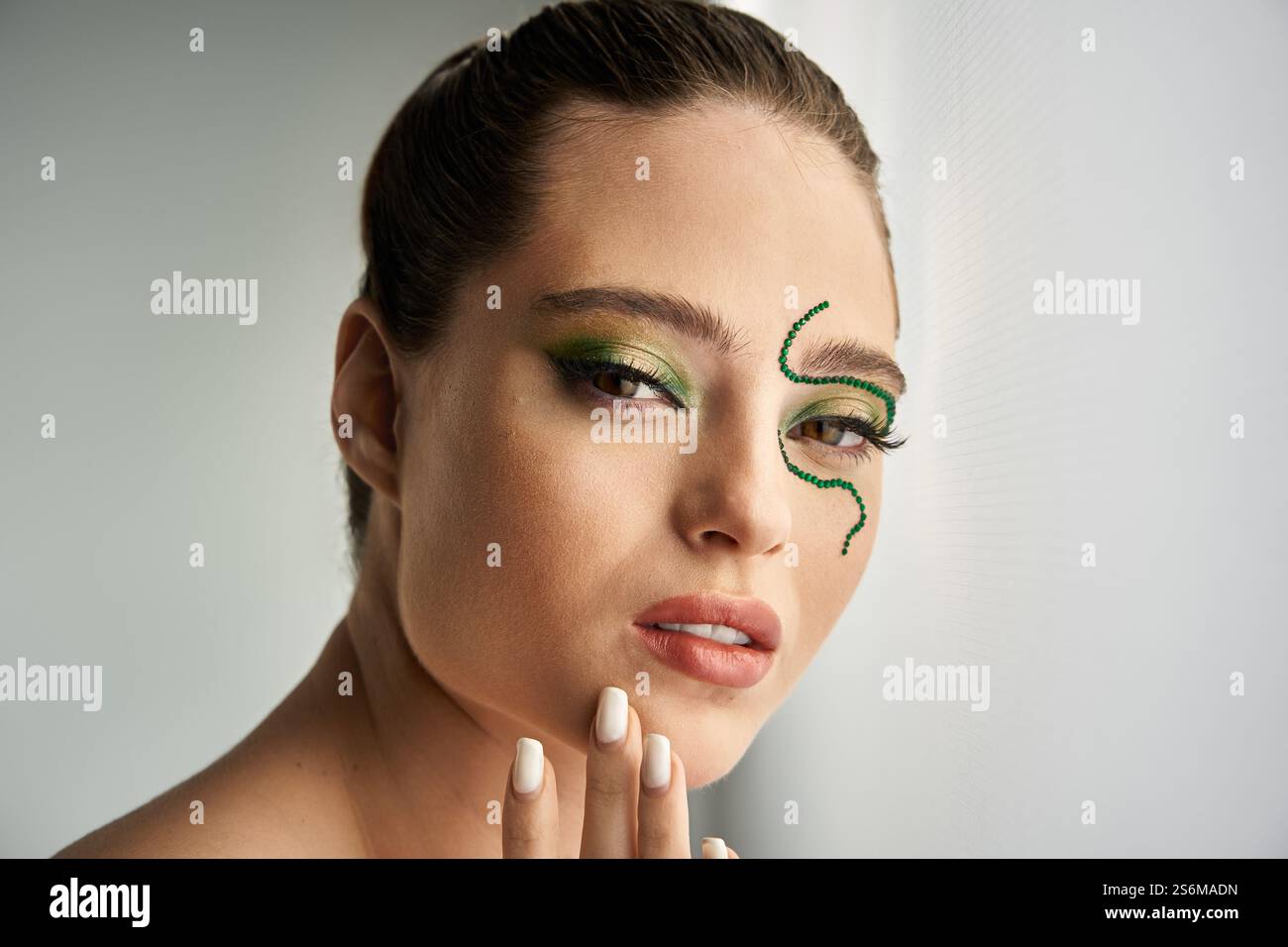 A beautiful young woman showcases captivating snake-inspired makeup ...