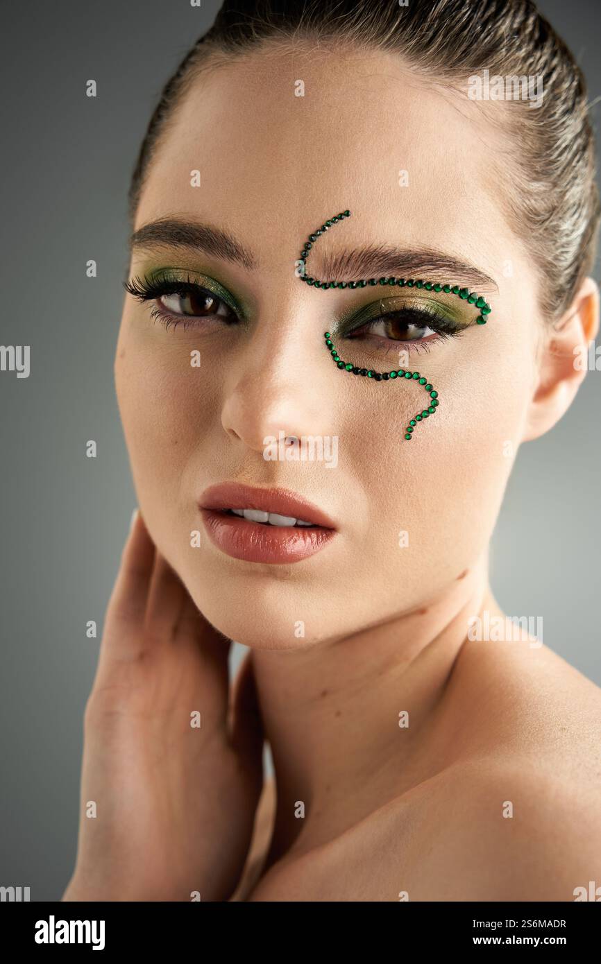A beautiful young woman poses in a studio, showcasing impressive snake ...