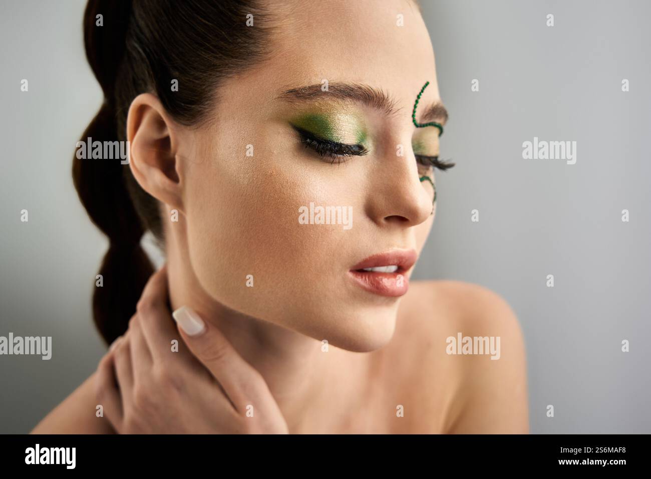 A beautiful young woman showcases intricate snake makeup artistry in a ...