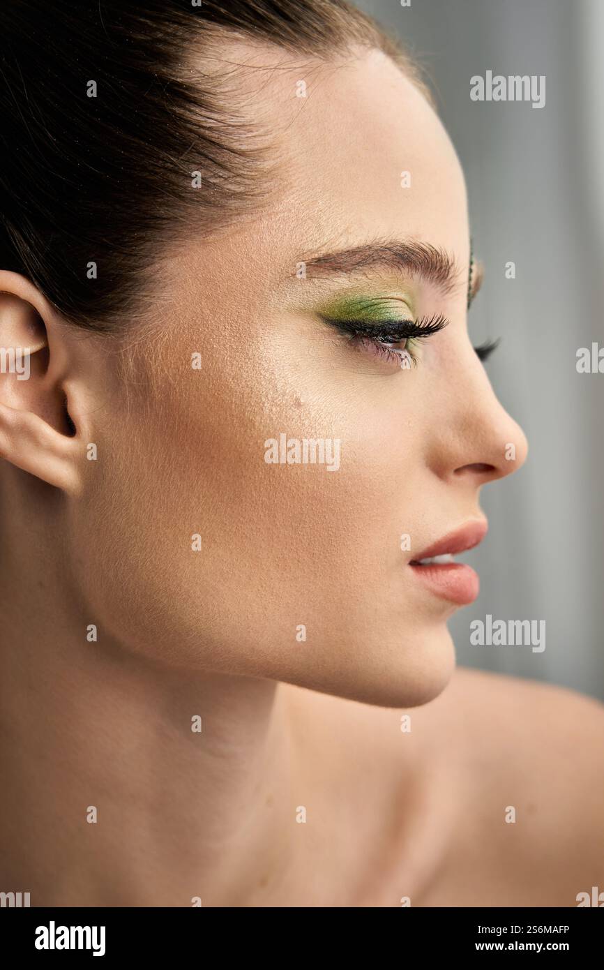 A young woman models green makeup in a studio Stock Photo - Alamy