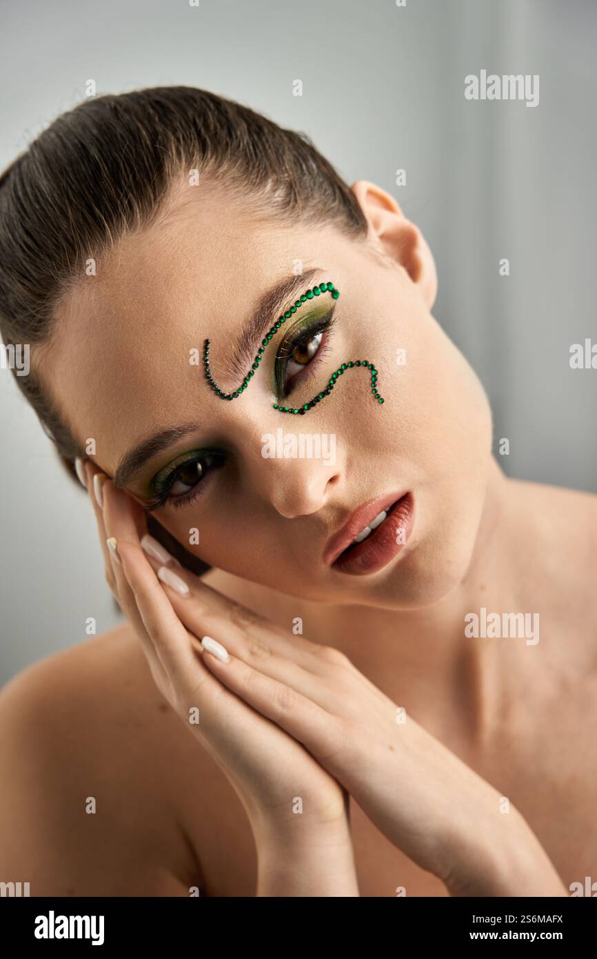 Beautiful young woman elegantly displays striking snake makeup artistry ...