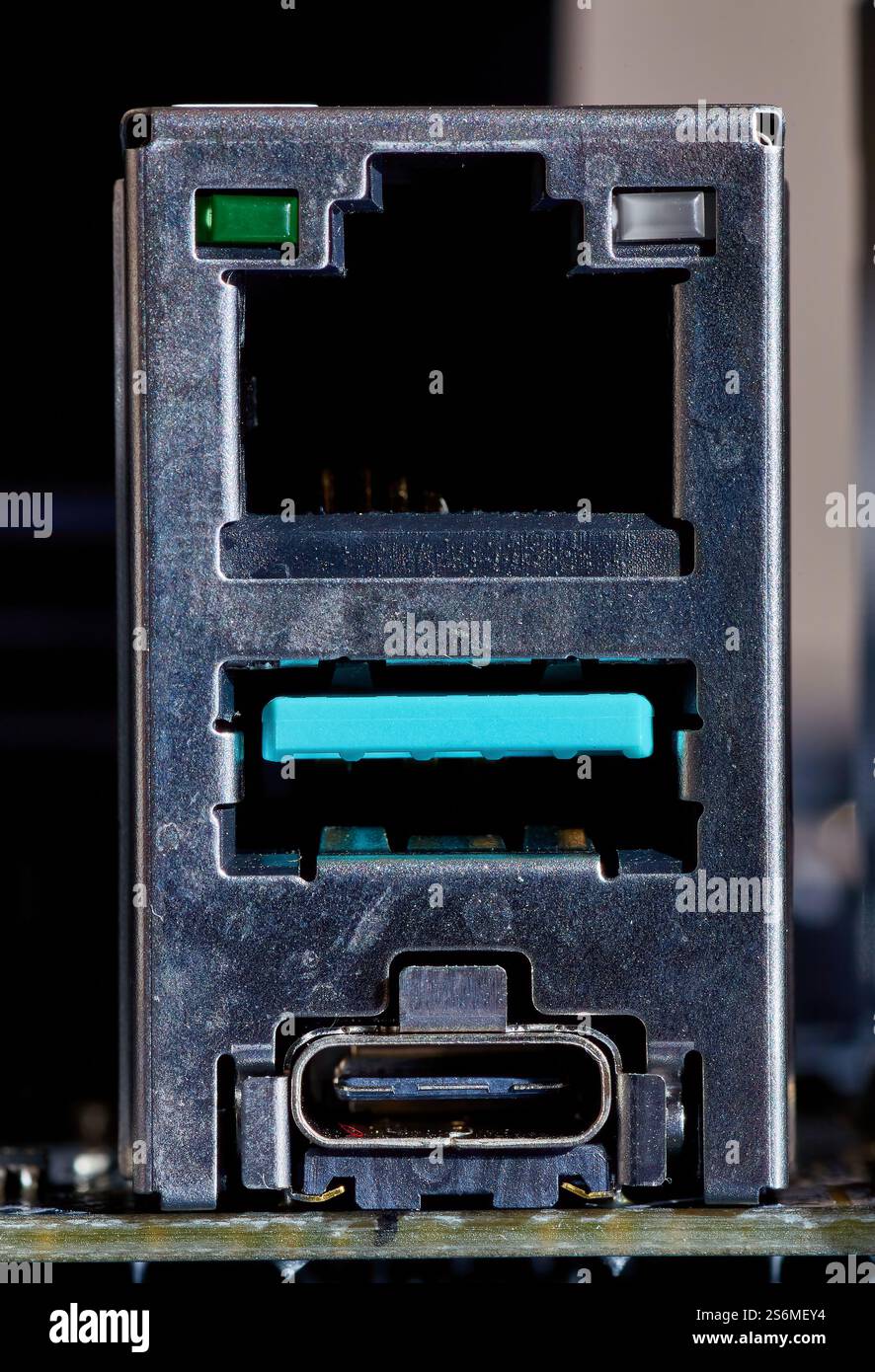 A close-up view of an Ethernet port, a teal-colored USB port, and a USB ...