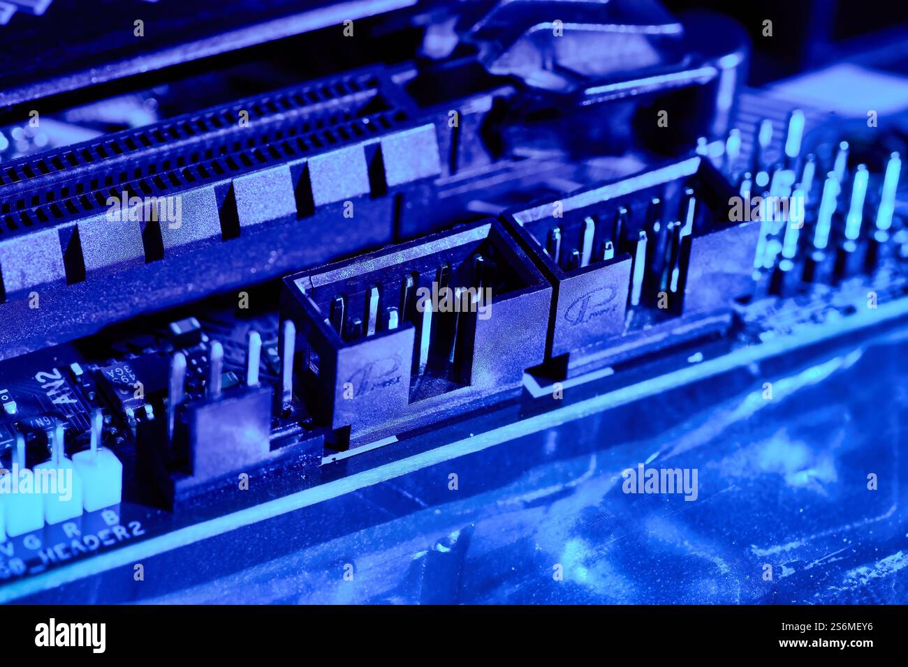 A detailed close-up of various motherboard connectors and pins ...