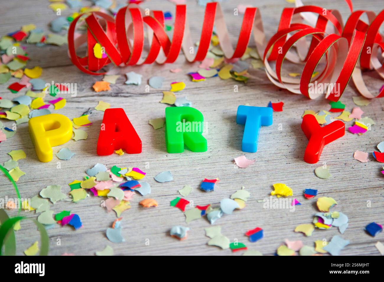 Party lettering with colorful letters and confetti Stock Photo - Alamy