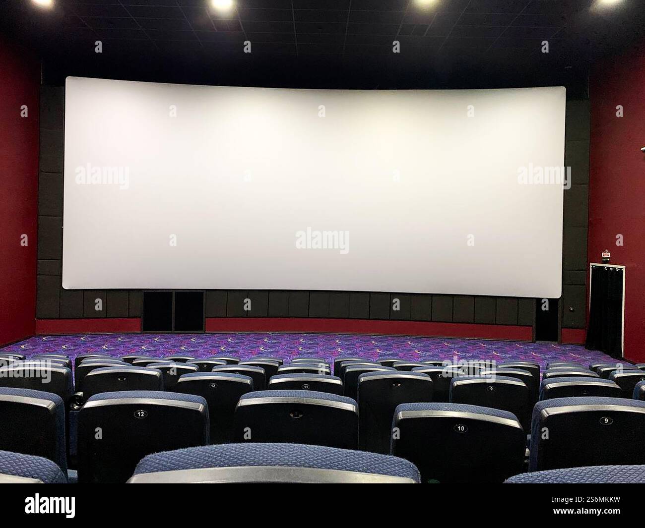 Cinema hall with a large white screen Stock Photo - Alamy