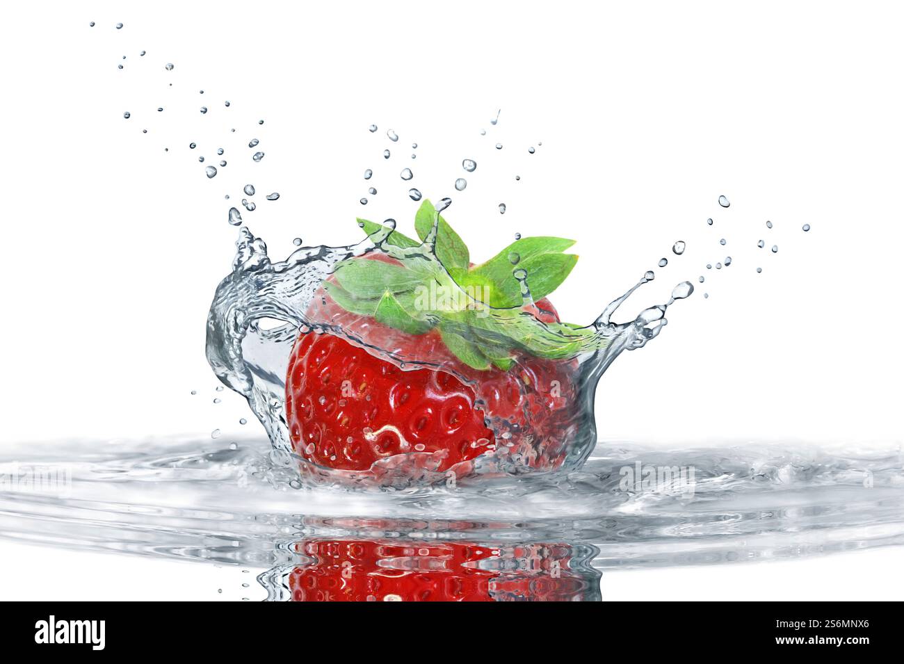 Strawberry falling into water Stock Photo - Alamy