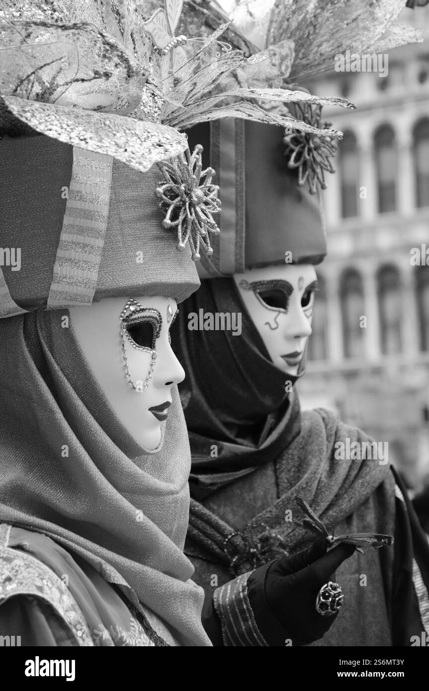 Noble couple masks in costumes decorated with flowers, butterflies and ...