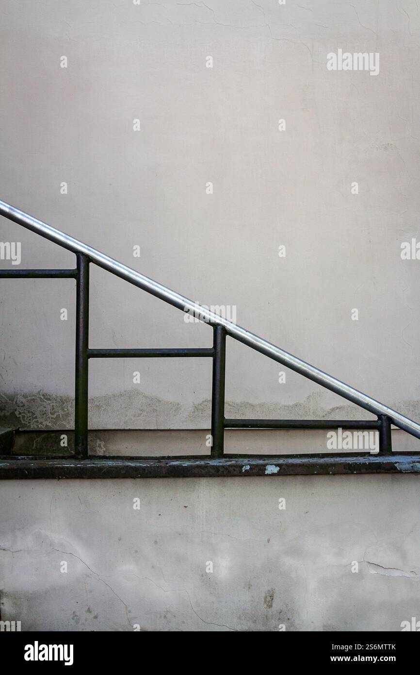 Stainless steel handrail on an outdoor plaster wall. Architectural ...
