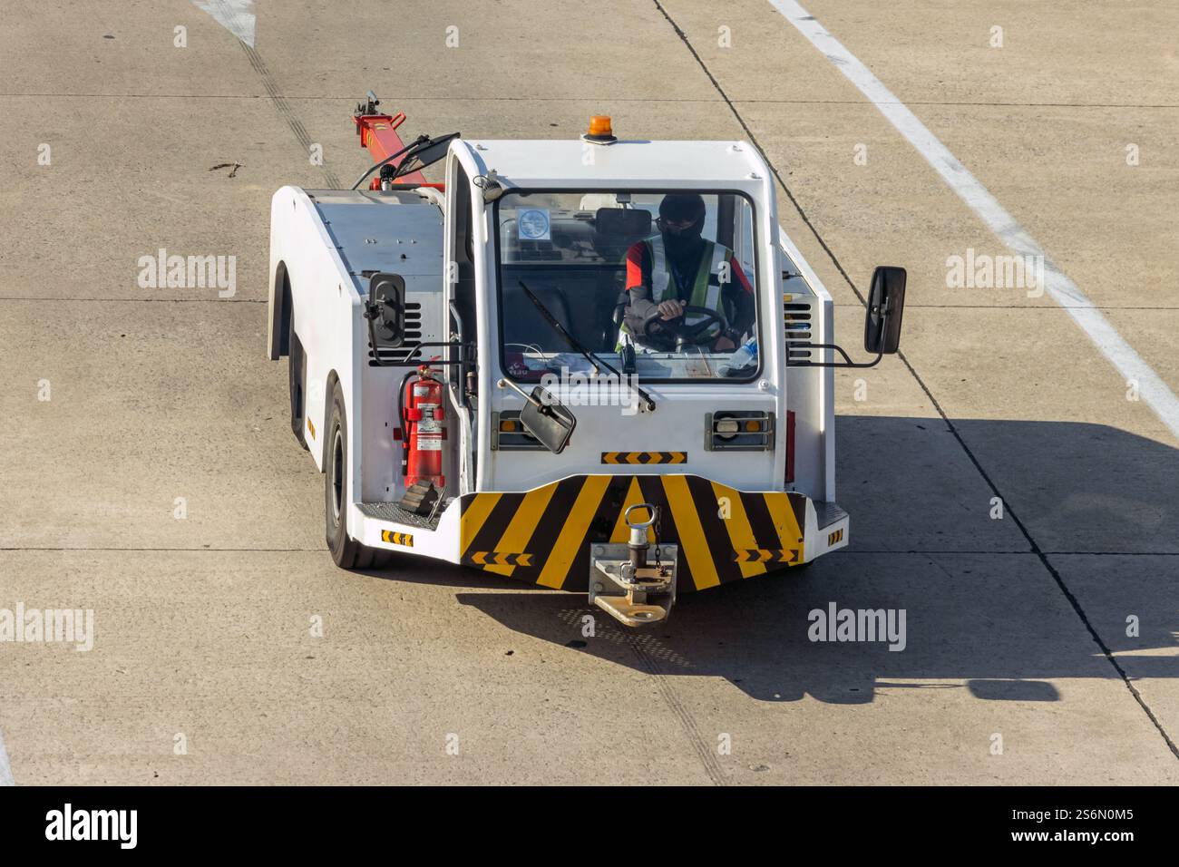 Towing tractor driving on a runway Stock Photo - Alamy