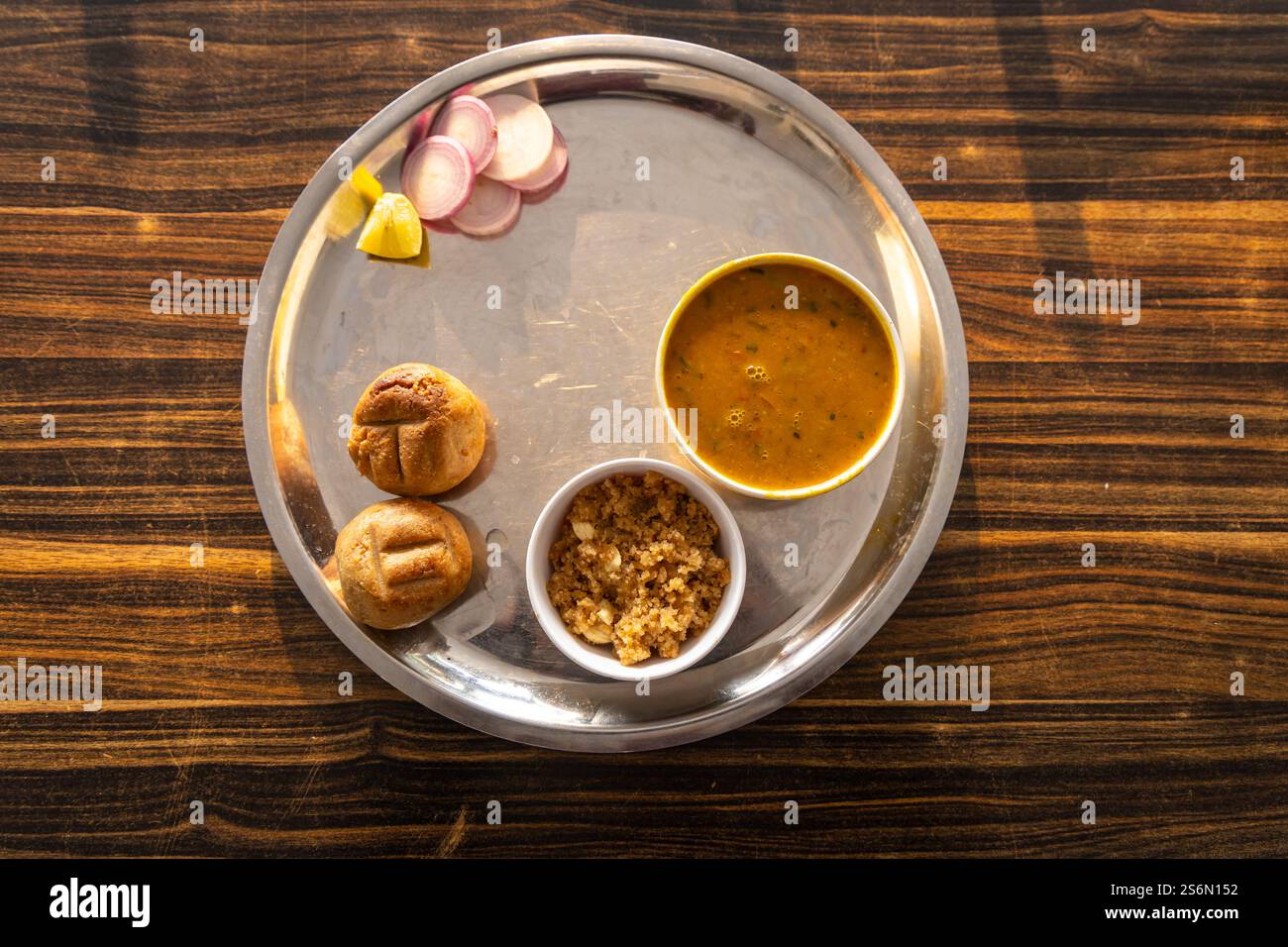 authentic indian traditional food dal bati churma served in steel plate ...