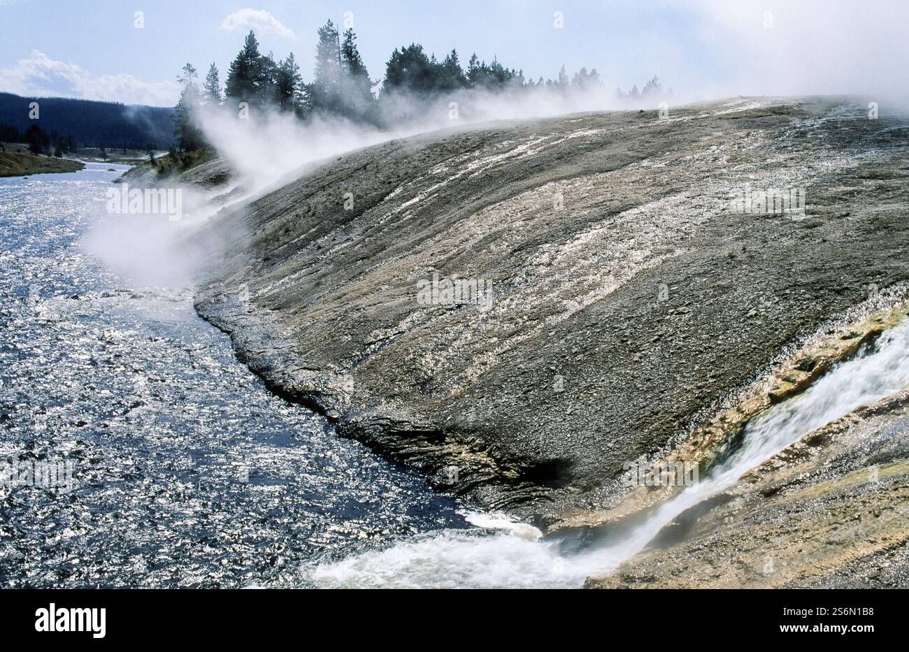 Boiling hot thermal water pours into a river Stock Photo - Alamy