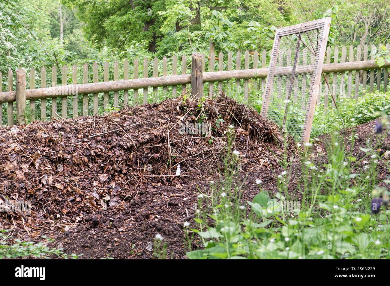 Compost heap with ripe compost and sieve Stock Photo - Alamy