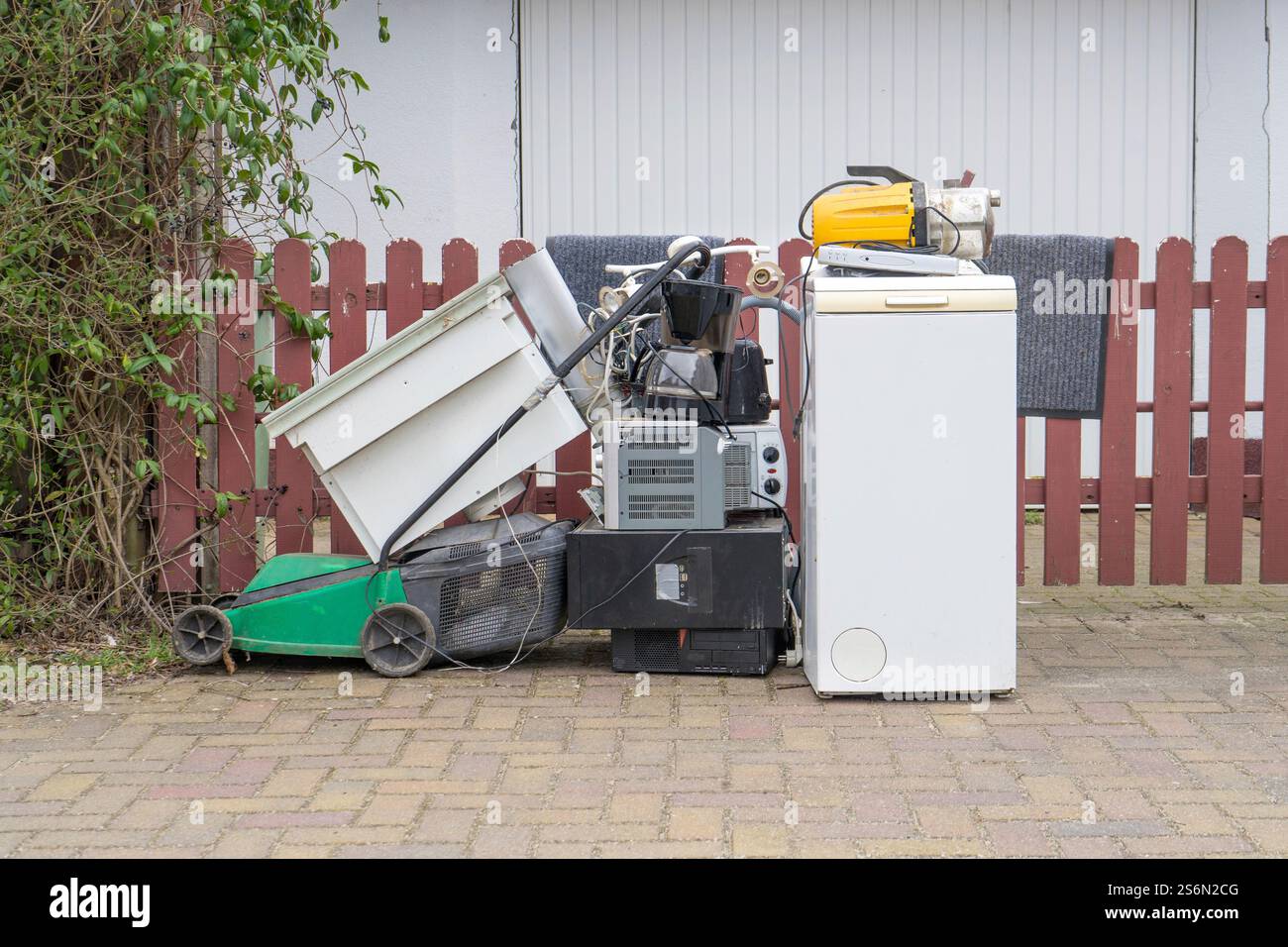 Pile of bulky waste with old electrical appliances by the roadside ...