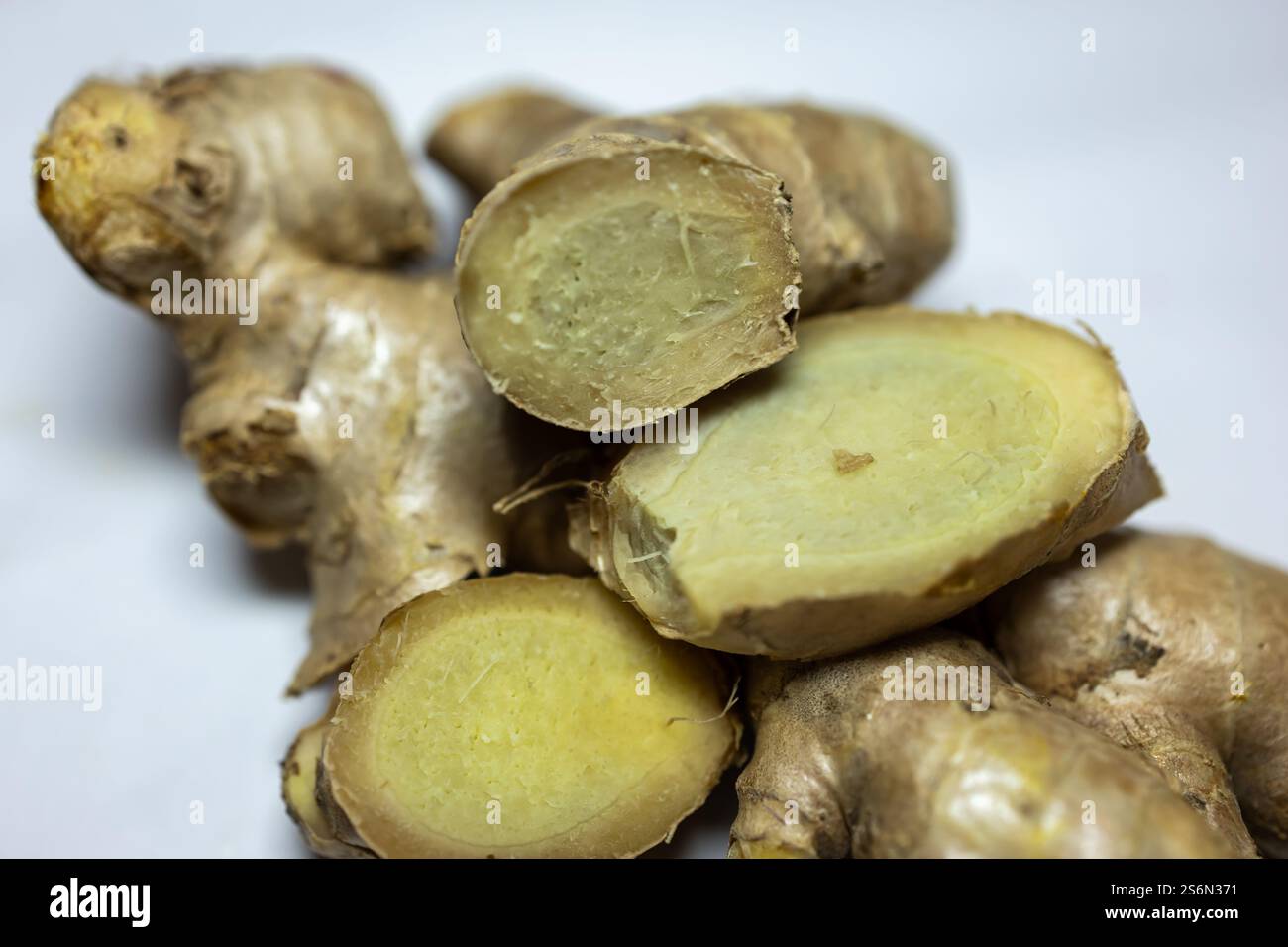 fresh raw ginger slice close-up studio shot with blurred white ...