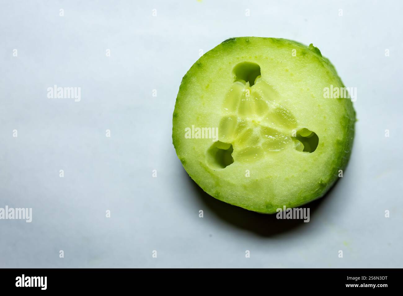 slice of fresh raw Cucumber in studio light shot on white background ...