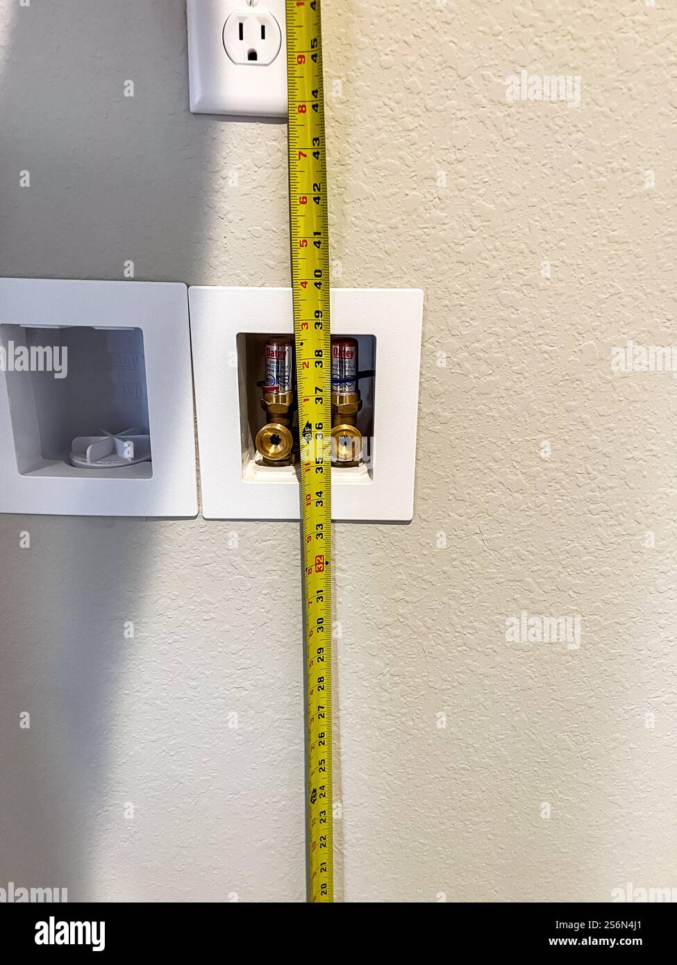 Laundry Room Utility Hookups and Outlet Stock Photo - Alamy