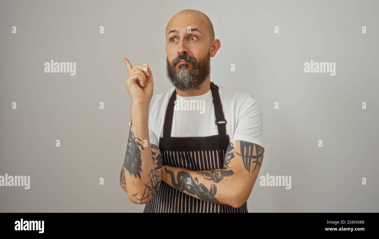 Hispanic man with tattoos, bald head, and beard wearing a white shirt ...