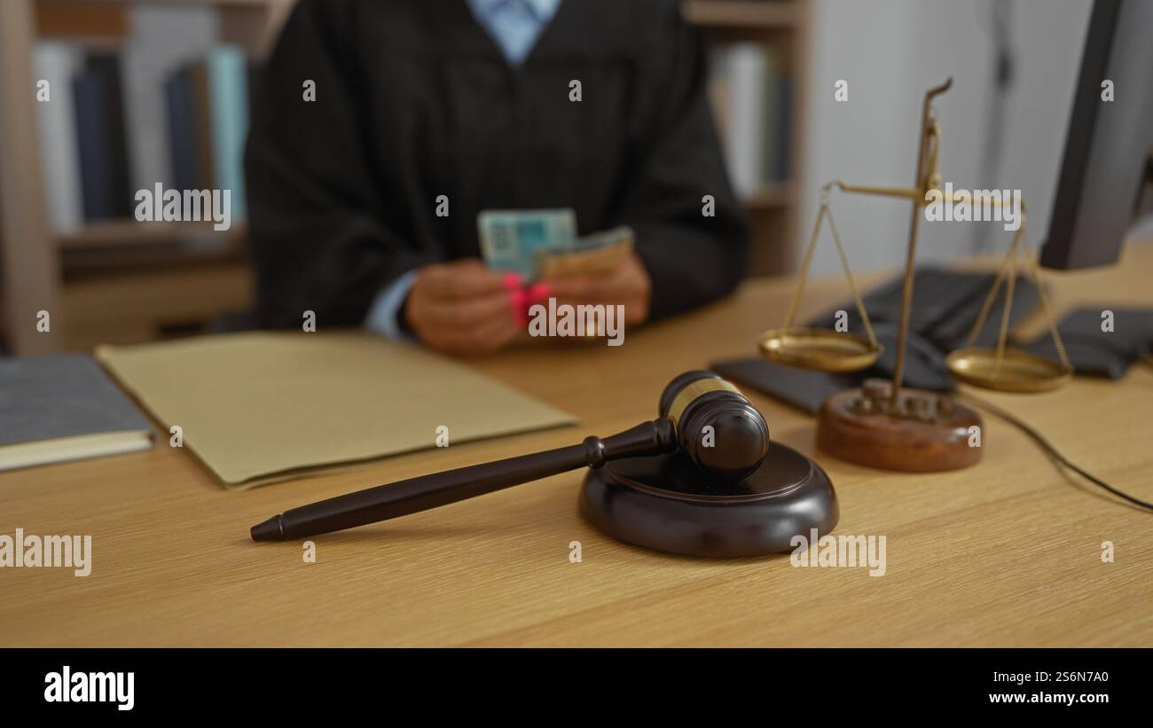 Judge counting money in court office with gavel balance and folder on ...