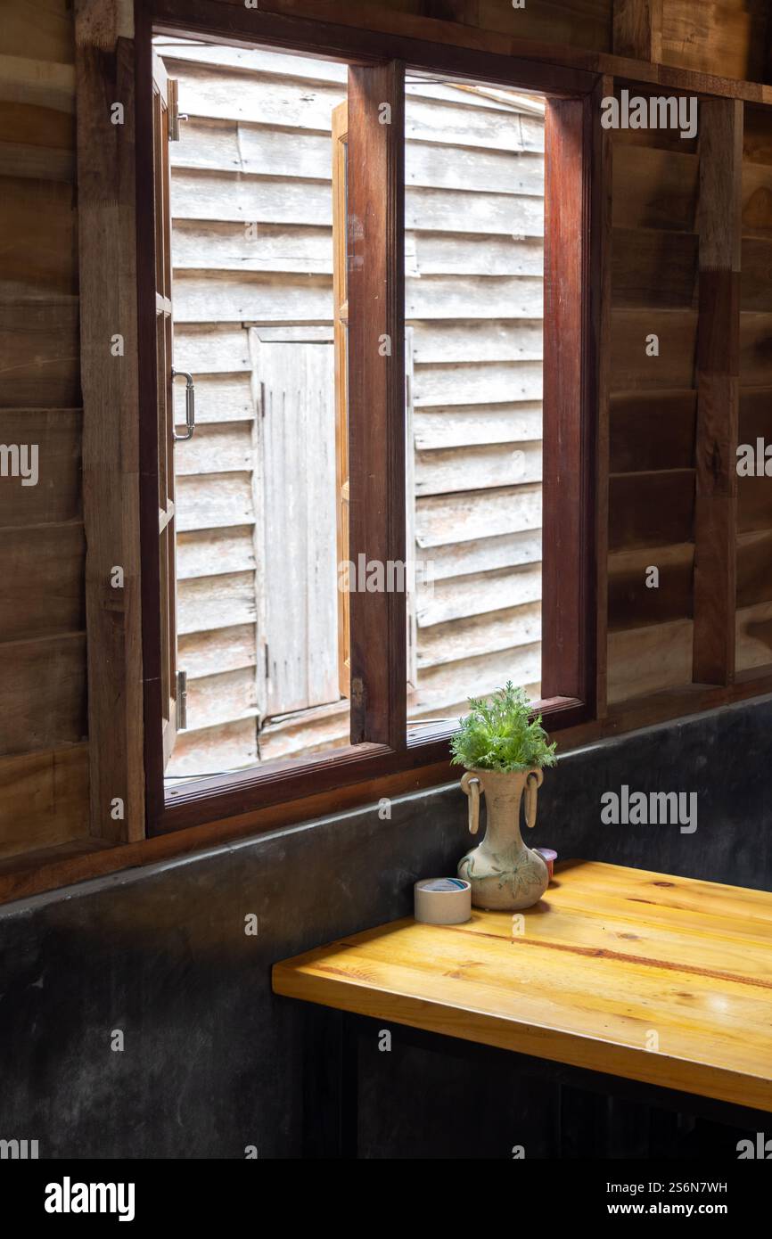 Open window above table in wooden house Stock Photo - Alamy
