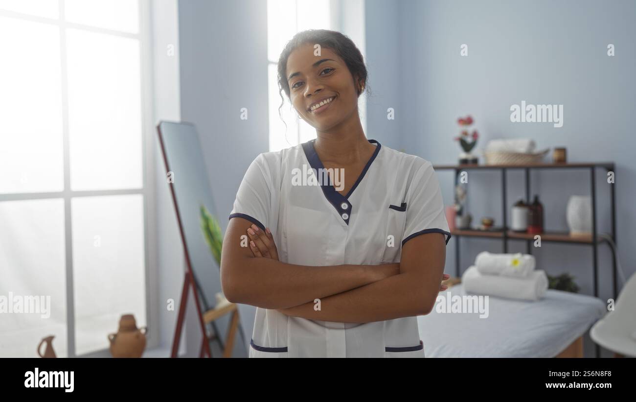 Female spa worker standing confidently in a wellness center room with ...