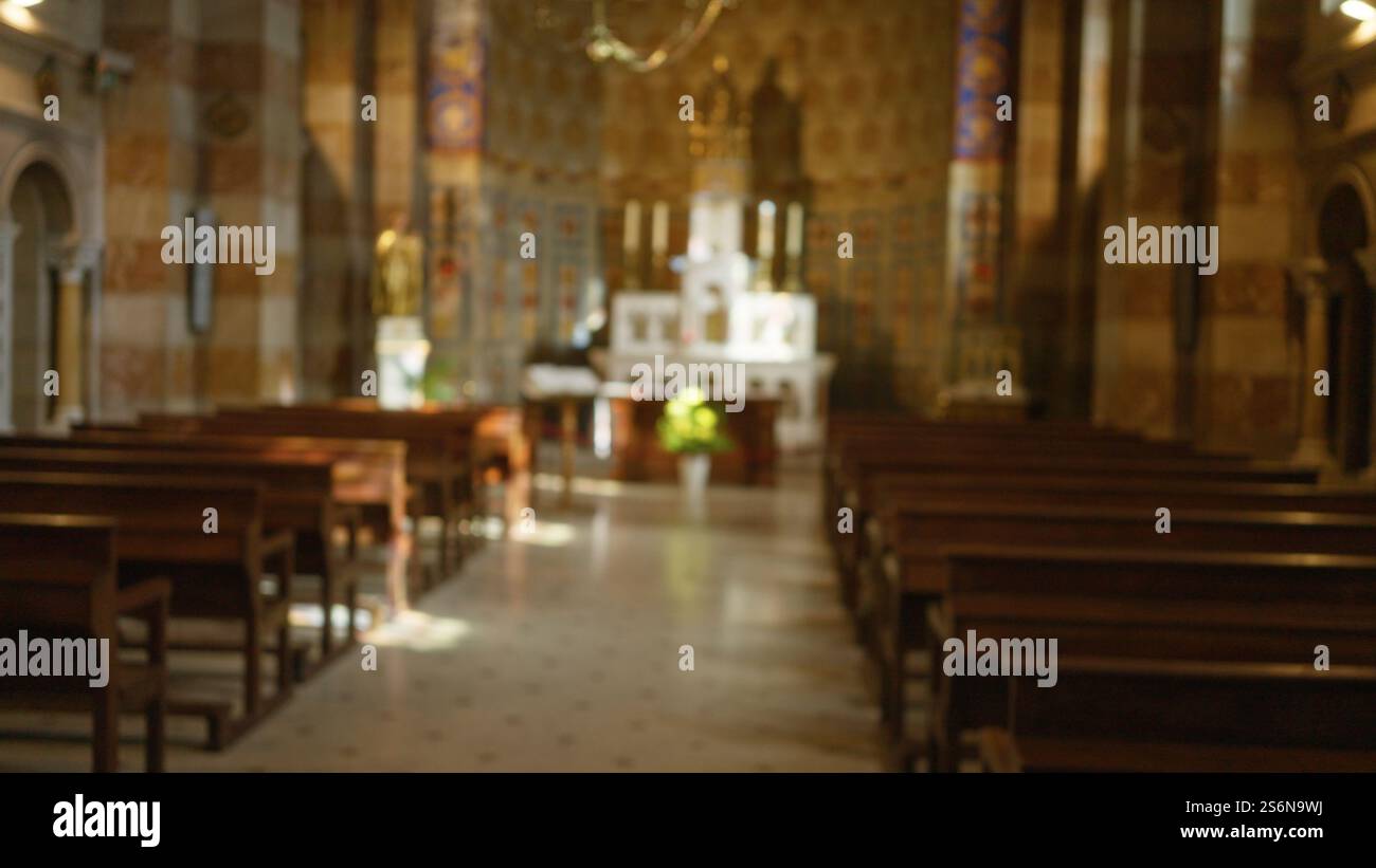 Blurred view of an indoor church setting with a focus on empty pews ...
