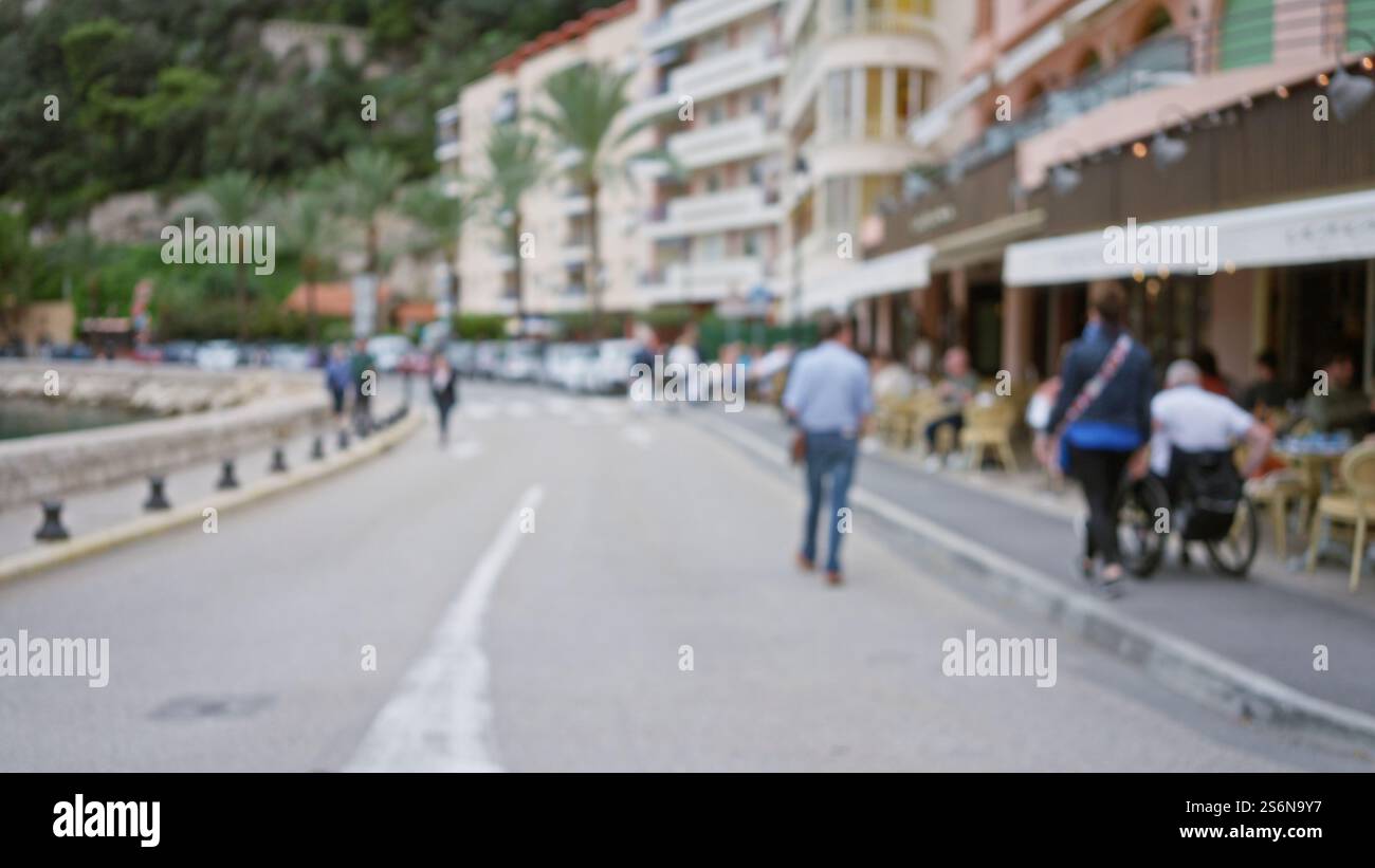 Street view in monaco with defocused people walking along a luxury ...