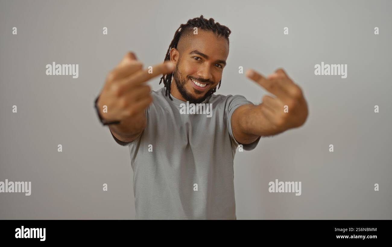 Young man with braids showing middle fingers on an isolated white ...