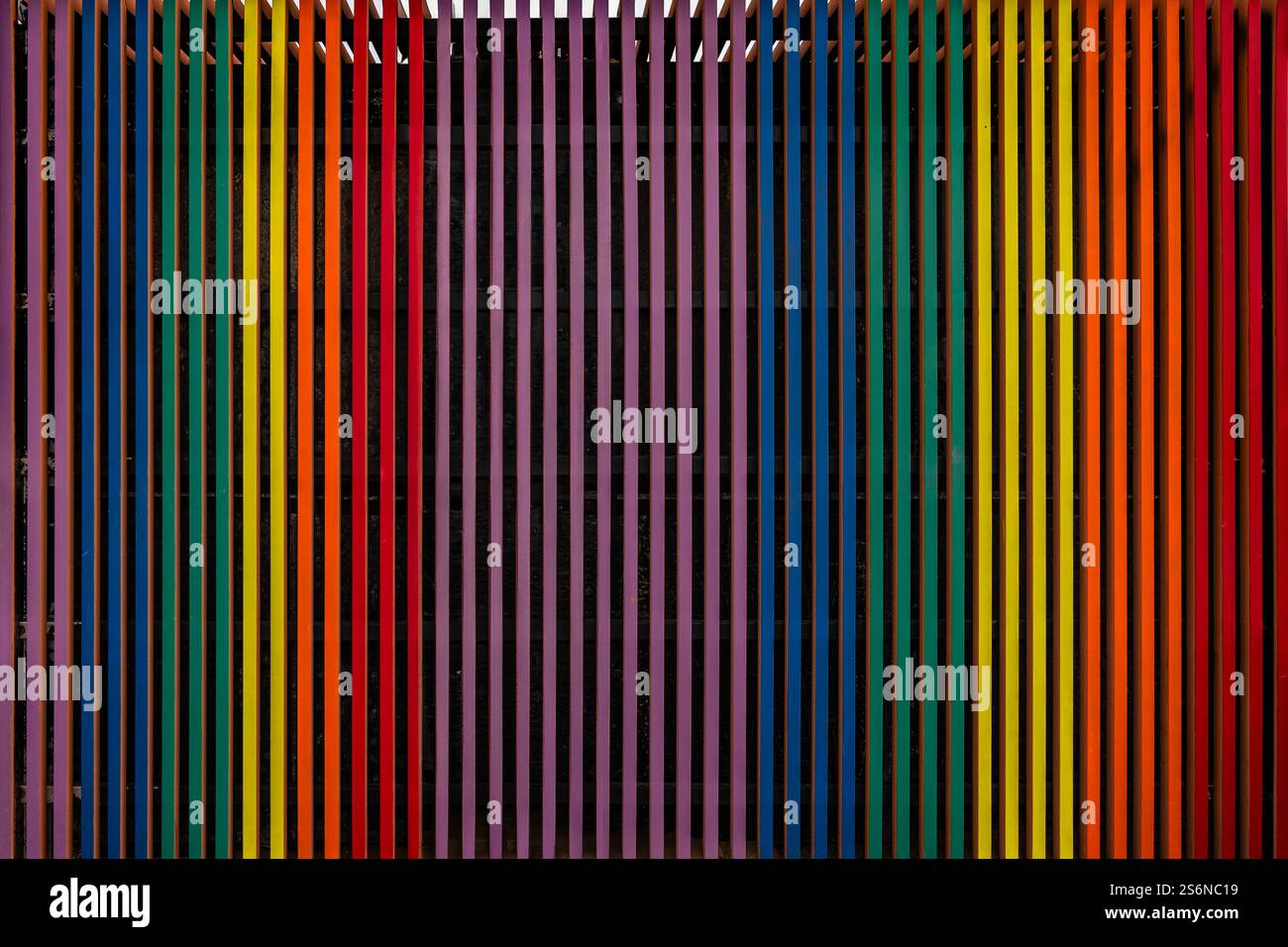A colorful striped wall with a rainbow of colors. The wall is made of ...