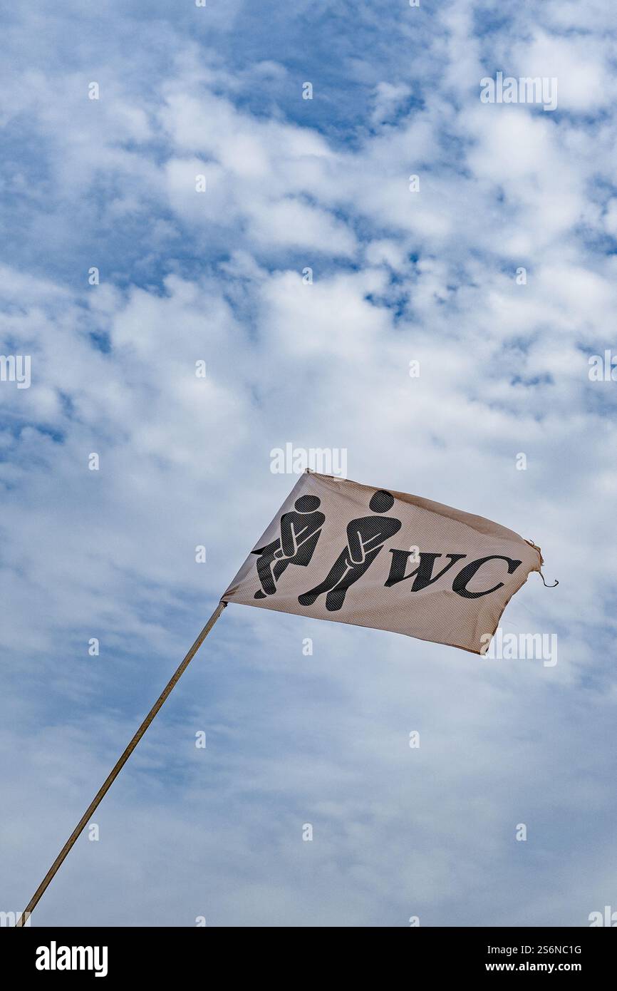 A flag with the letters WC on it is flying in the sky. The flag is ...