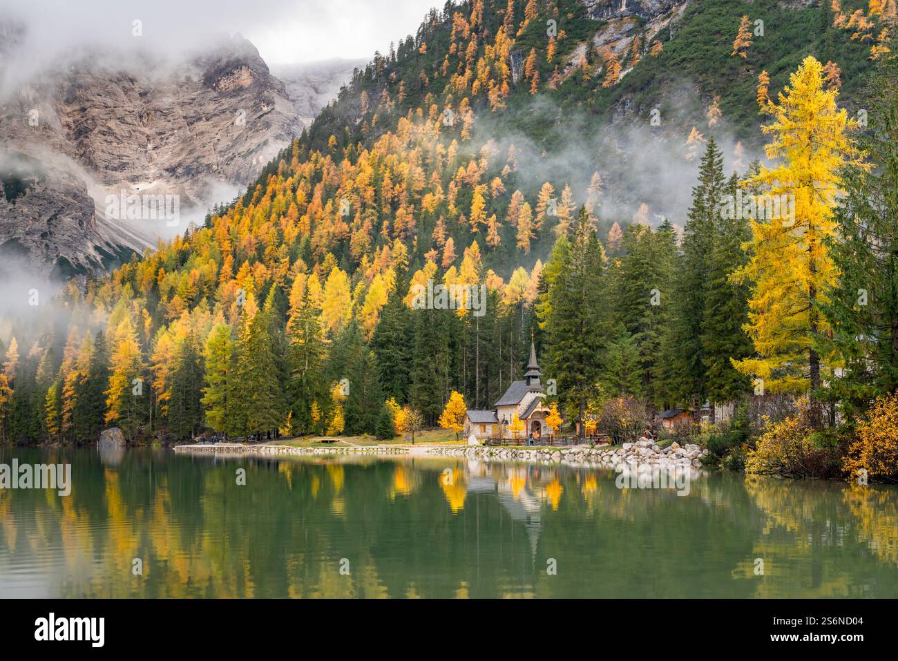 Lake Braies with fall foliage color and reflections in the Dolomites of ...
