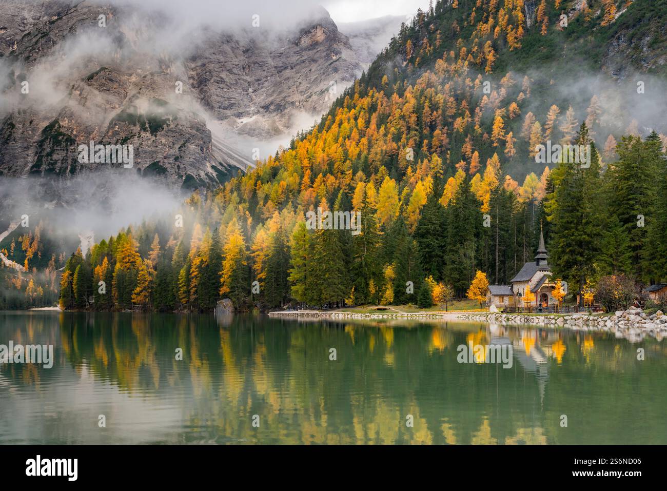 Lake Braies with fall foliage color and reflections in the Dolomites of ...